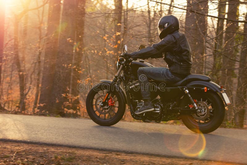 Young Man Riding Chopper on Road in Forest Stock Image - Image of ...
