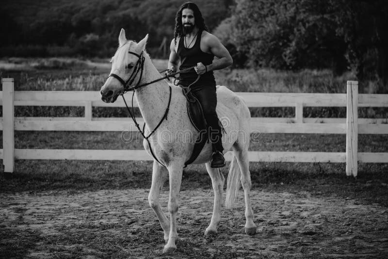 Young Man Riding a Horse. Handsome Macho Cowboy Riding on a Horse ...