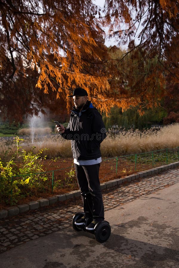 Young Man Riding Hoverboard with Mobile Phone Stock Photo - Image of ...