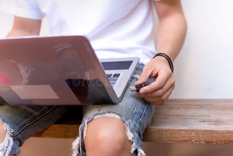 Young Man Copying Data from Notebook To Usb Flash Drive Stock Photo ...