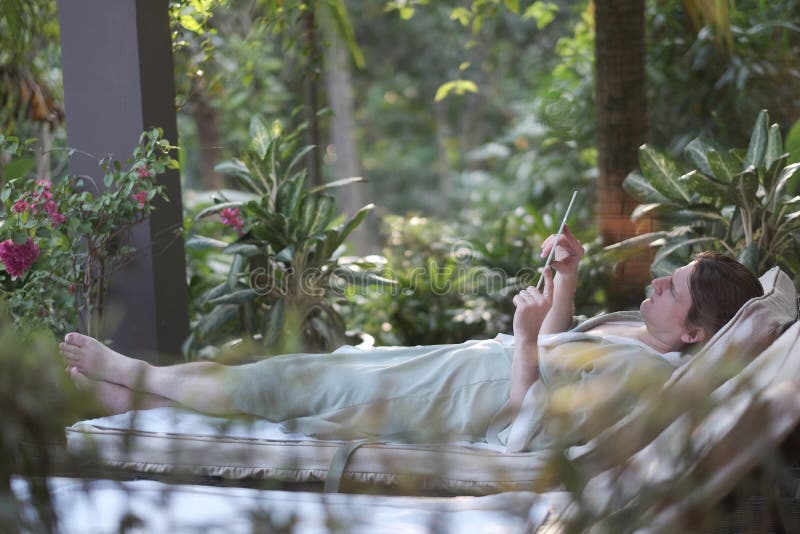 A Young Man in a Robe Lies on a Sofa Stock Photo - Image of leisure ...