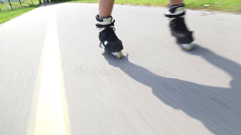 Young Man Rollerblading in Park on a Beautiful Day, Feet Going ...
