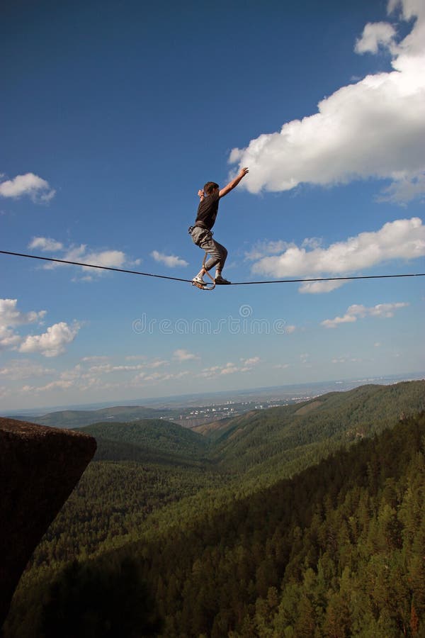 A Young Man Ropewalker Balancing Over the Abyss. Stock Image - Image of ...