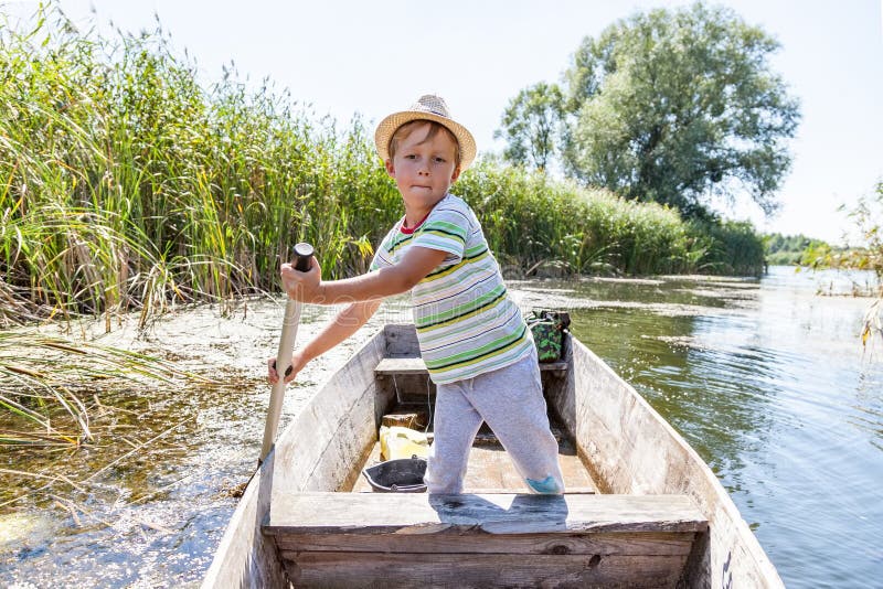 Young man rowing a boat stock photo. Image of hard, active - 118054670