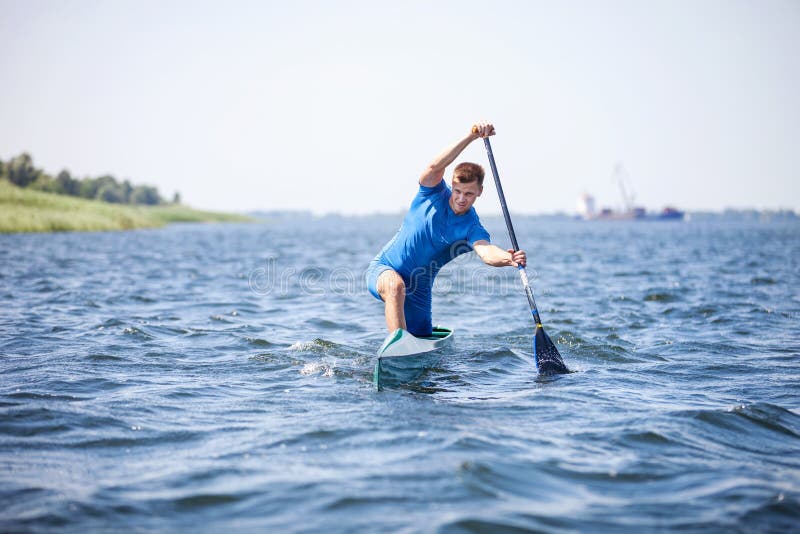 Young Man Rowing in Canoe Along a River. Stock Photo - Image of healthy ...