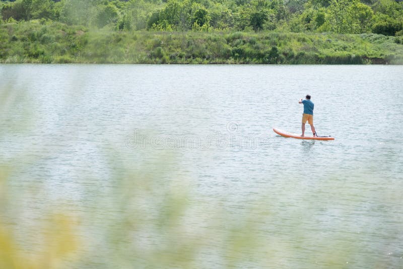 Young Man Rowing Sup Board after Water Surf Session Stock Photo - Image ...