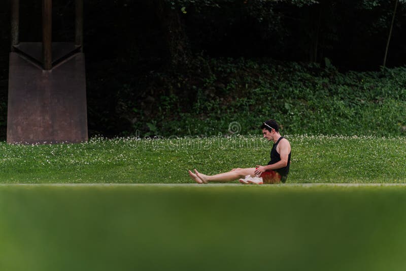 Young Man Rubbing His Legs after a Track Running Session Stock Photo ...