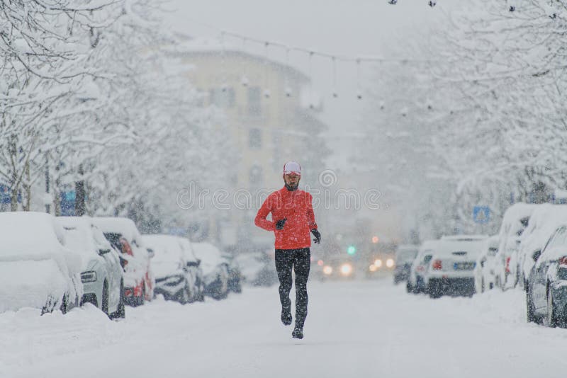 Young Man Runner Under a Snowfall in the City Stock Image - Image of ...