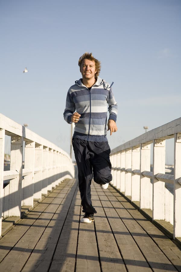 Happy Young Man is Running in a Field Stock Photo - Image of white ...