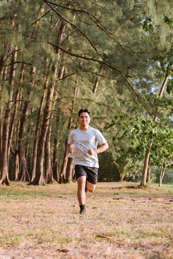 Young Man Running and Doing Workout Outdoors at the Park. Stock Image ...