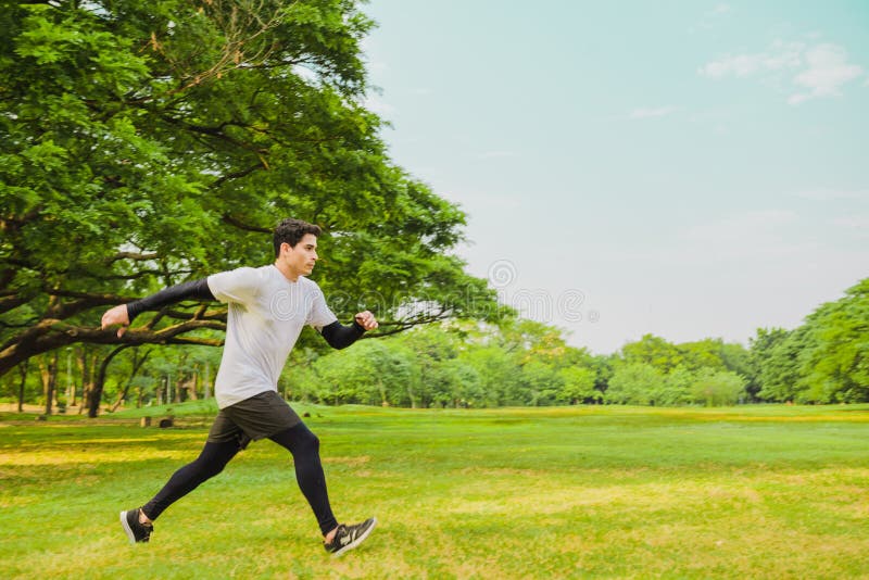 Young Man Running in the Green Park Stock Photo - Image of outdoor ...