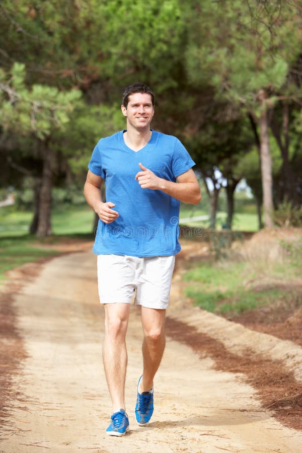 Young man running in park stock photo. Image of caucasian - 16824102