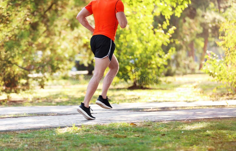 Young man running in park stock photo. Image of green - 125092350