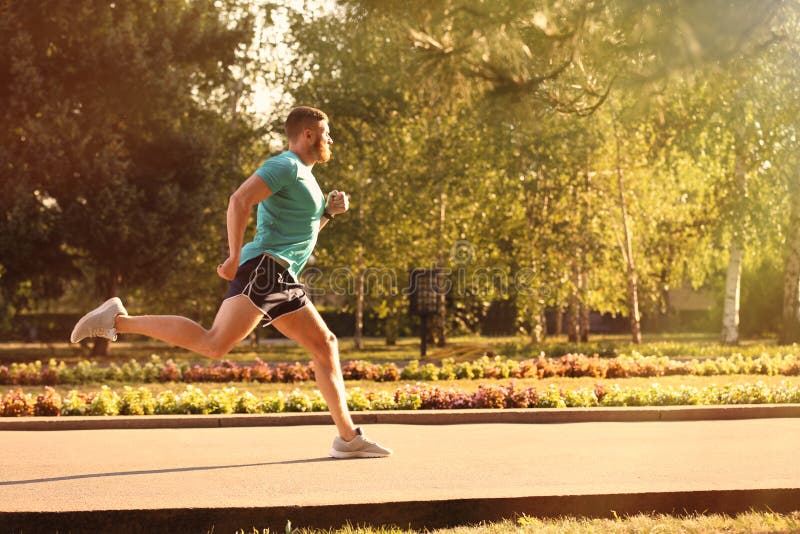 Young man running in park stock photo. Image of athletic - 125192668