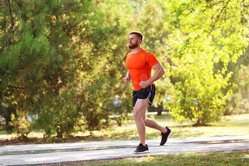 Young man running in park stock image. Image of park - 125192703