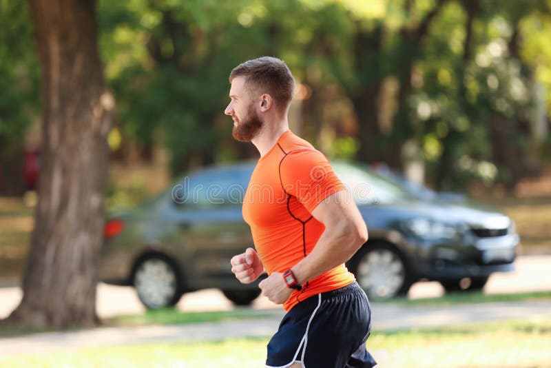 Young man running in park stock image. Image of motivation - 125192711
