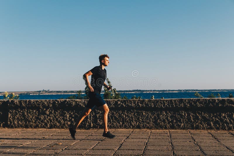Young Man is Running in a Park Stock Image - Image of male, adult ...
