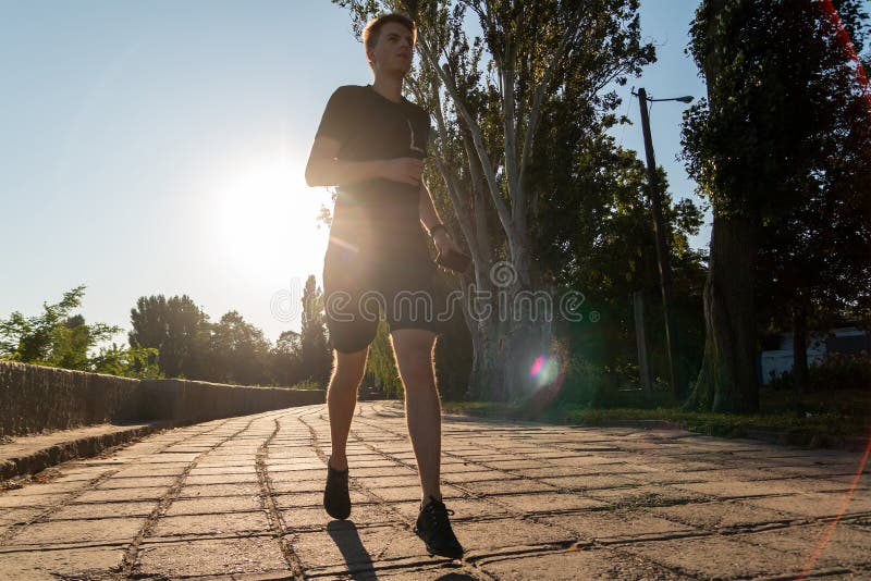 Young Man is Running in a Park Stock Image - Image of body, male: 157977761