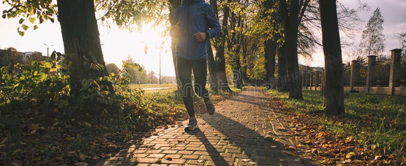 Young Man is Running through the Pathway in the Fall Stock Photo ...