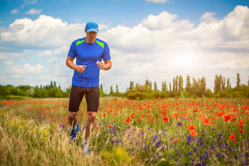 Young Man Running on Poppy Field Stock Photo - Image of foot, runner ...