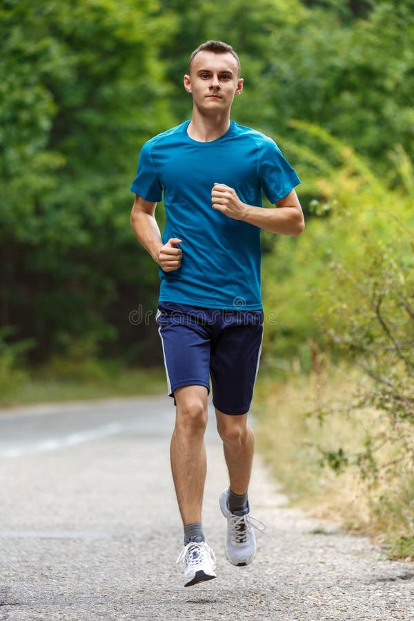 Boy jogging through forest stock photo. Image of fitness - 85247592