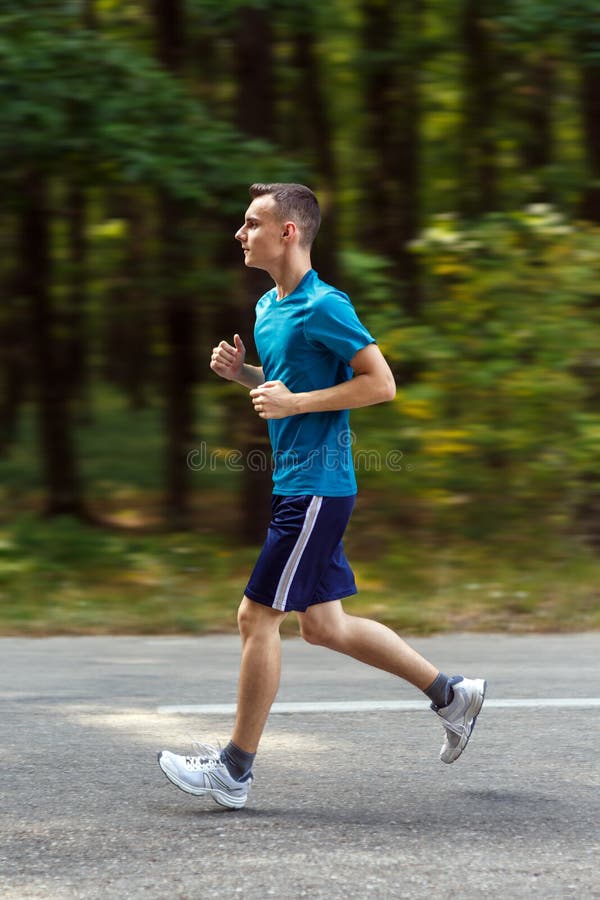 Boy jogging through forest stock photo. Image of healthy - 85261610