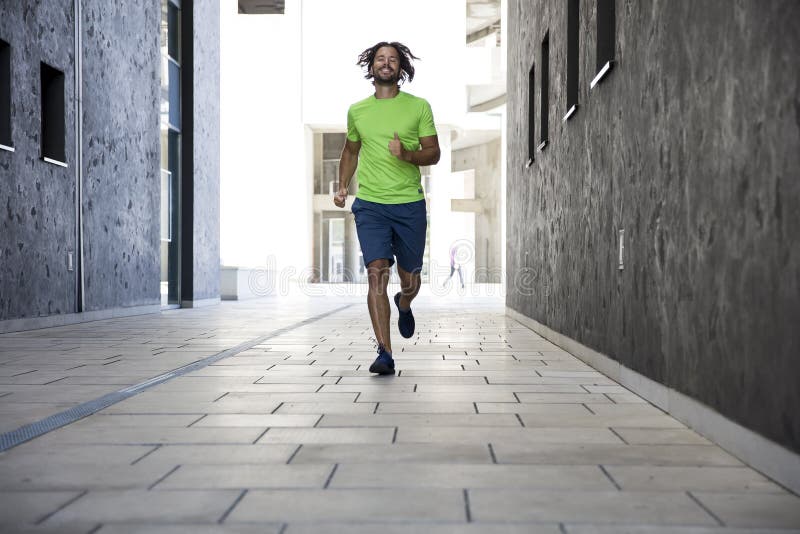 Young Man Running on the Street in Urban Environment Stock Photo ...