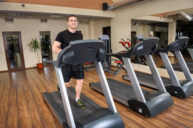 Young Man Running at Treadmill in Gym Stock Image - Image of fitness ...