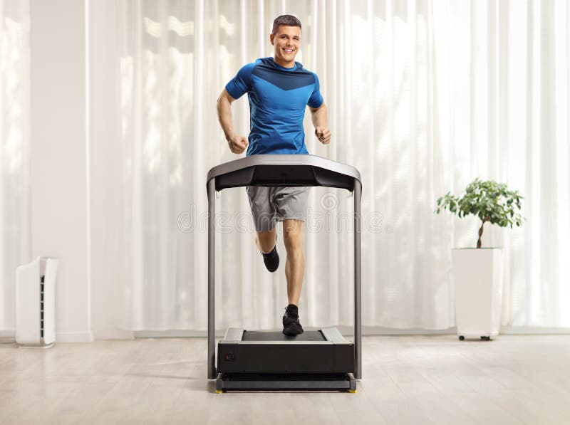 Young Man Running on a Treadmill at Home Stock Photo - Image of ...