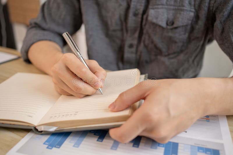Young Man S Hand Writing an Important Message in Notebook ...