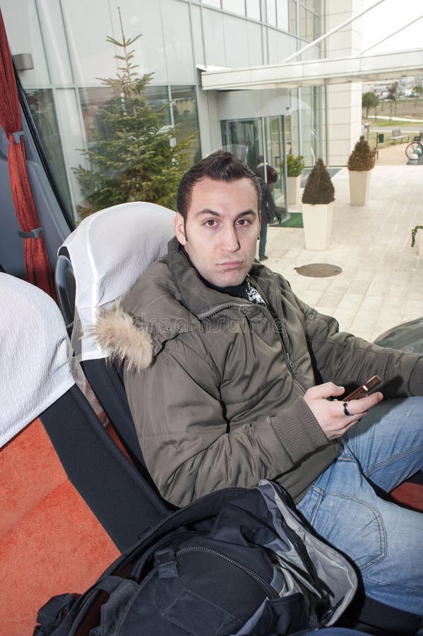 A young man sat in a bus stock photo. Image of cellphone - 55608212