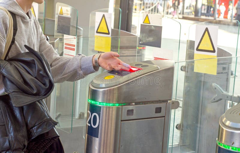 Young Man Scanning QR Code on Train Ticket on Turnstile Scanner To ...