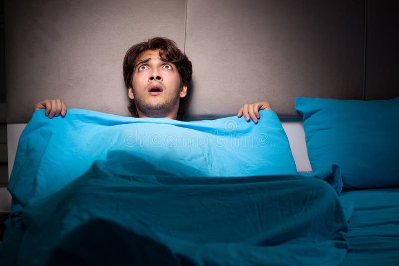 The Young Man Scared in His Bed Having Nightmares Stock Photo - Image ...