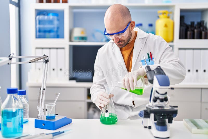 Young Man Scientist Measuring Liquid at Laboratory Stock Image - Image ...