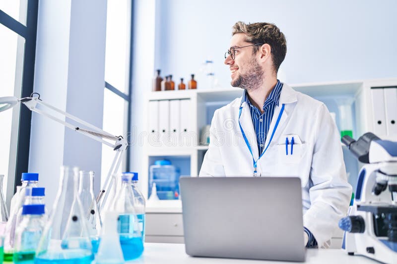 Young Man Scientist Smiling Confident Using Laptop at Laboratory Stock ...
