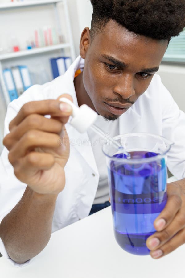 Young Man Scientist Using Auto-pipette with Flask in Medical Laboratory ...