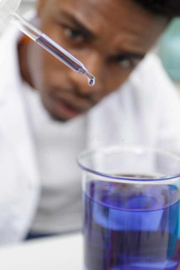 Young Man Scientist Using Auto-pipette with Flask in Medical Laboratory ...