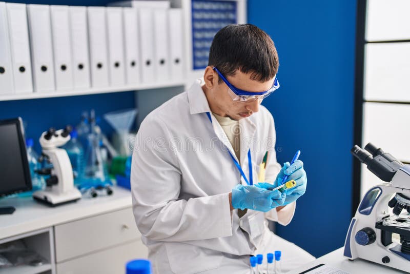 Young Man Scientist Writing on Test Tube at Laboratory Stock Photo ...