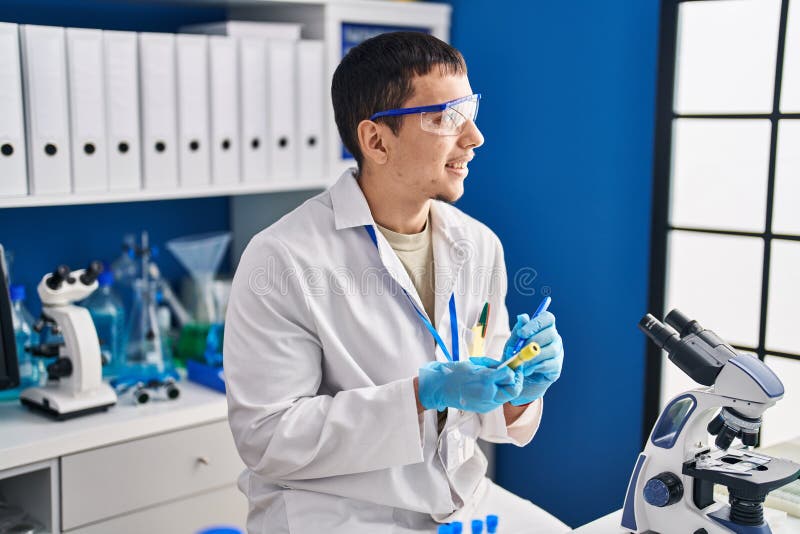 Young Man Scientist Writing on Test Tube at Laboratory Stock Photo ...