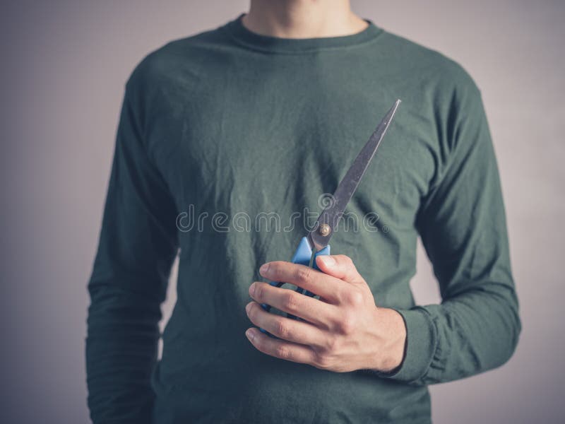Young man with scissors stock photo. Image of filtered - 55679872