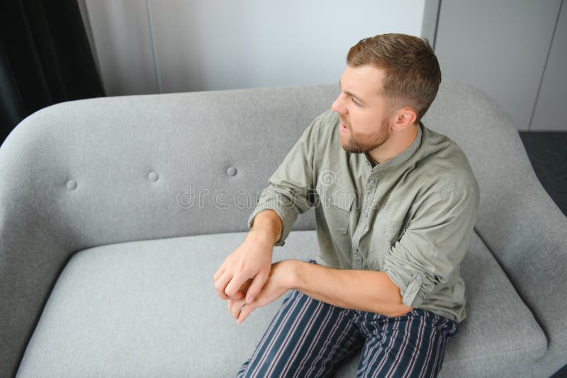 Young Man Scratching Hand Indoors, Space for Text. Allergies Symptoms ...