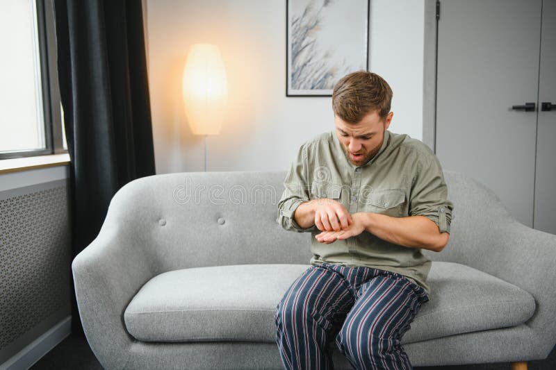 Young Man Scratching Hand Indoors, Space for Text. Allergies Symptoms ...