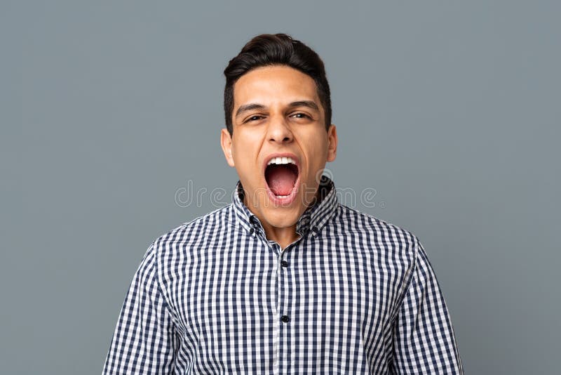 Young Man Screaming Loudly at Camera on Gray Background Stock Image ...