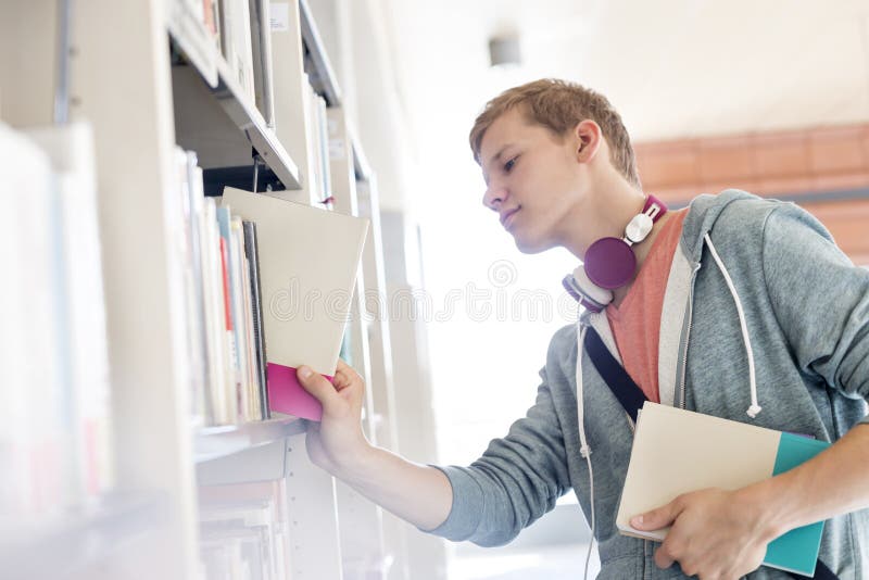 Young Man Searching for Book at University Library Stock Image - Image ...
