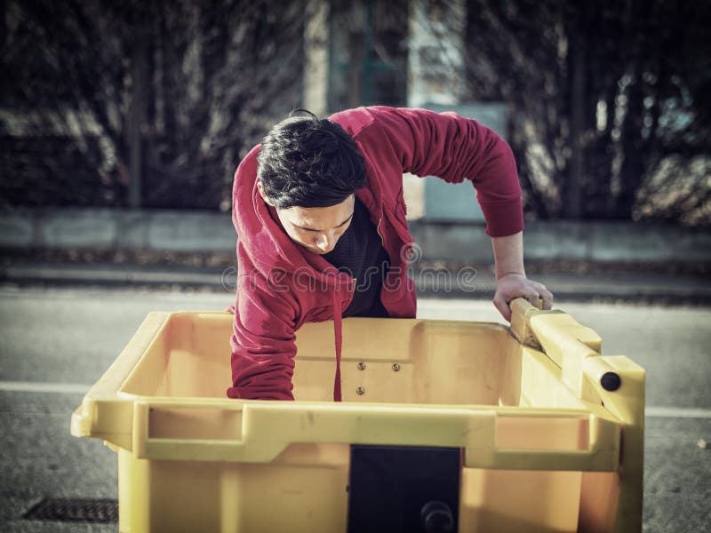 Young Man Searching Inside Garbage Bin for Stuff Stock Image - Image of ...