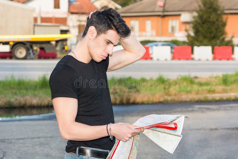 Young Man Searching for a Location from Printed Stock Image - Image of ...