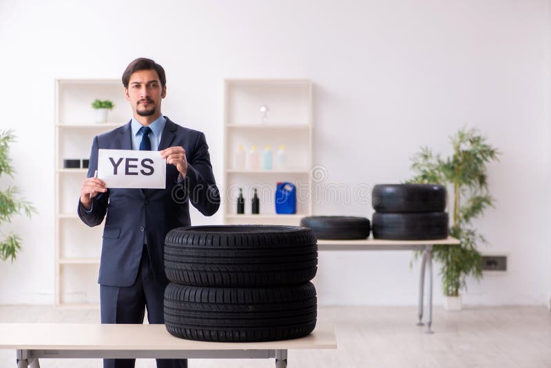 Young Man Selling Tires in the Office Stock Photo - Image of approval ...