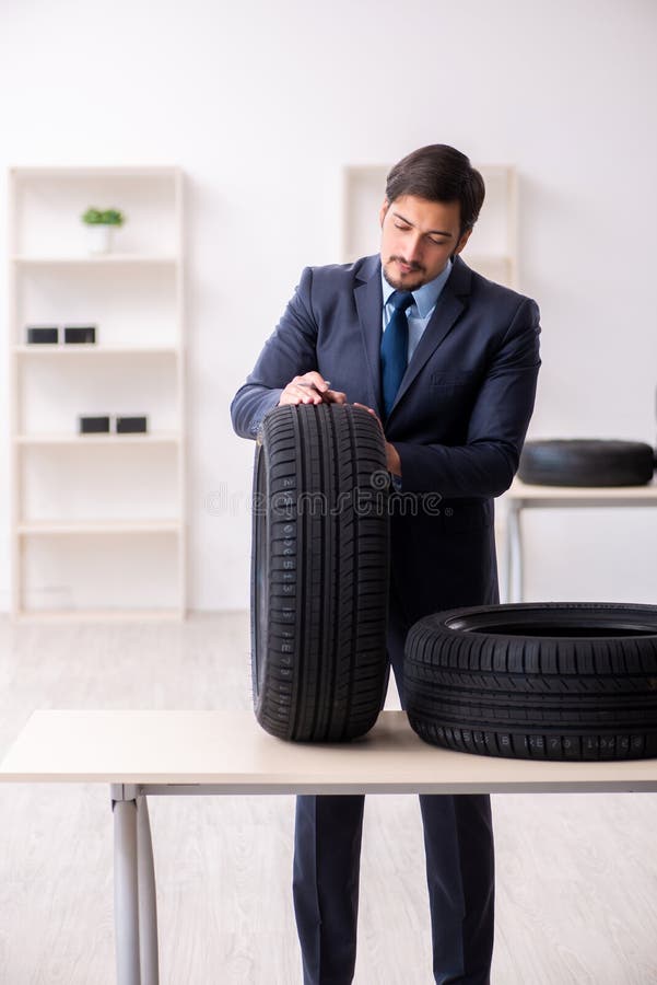 Young Man Selling Tires in the Office Stock Photo - Image of expertise ...
