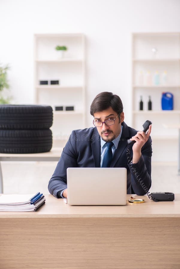 Young Man Selling Tires in the Office Stock Photo - Image of assistant ...