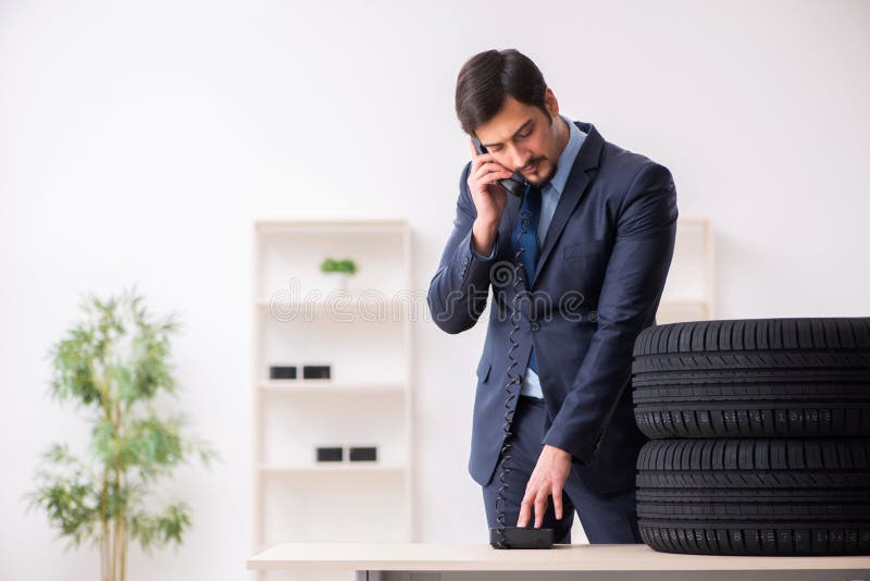 Young Man Selling Tires in the Office Stock Image - Image of warranty ...